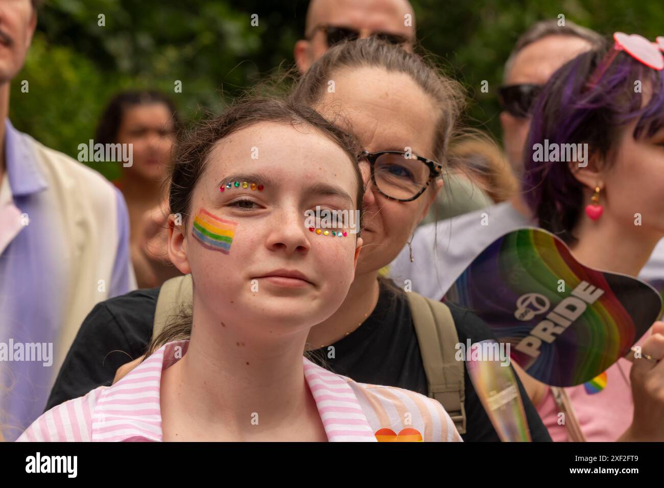 New York, United States. 30th June, 2024. A spectator with a pride flag ...