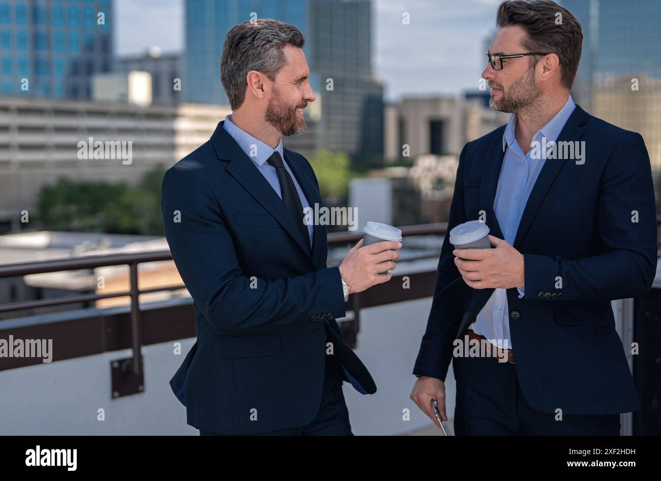 Client at business meeting. Two business men talking outdoors. Two ...