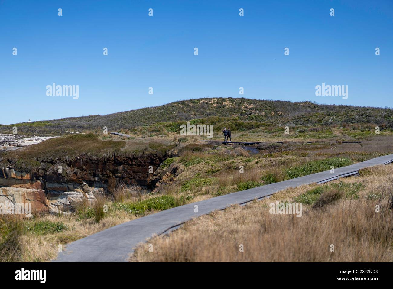 two people hiking grated walking track national park Stock Photo - Alamy