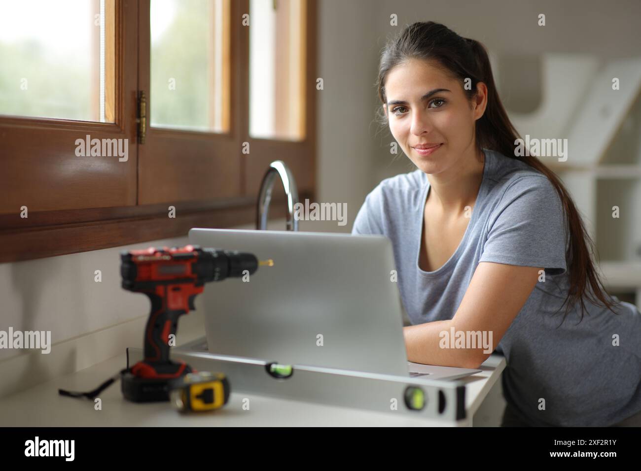 Single serious homeowner reforming house using laptop looking at you ...