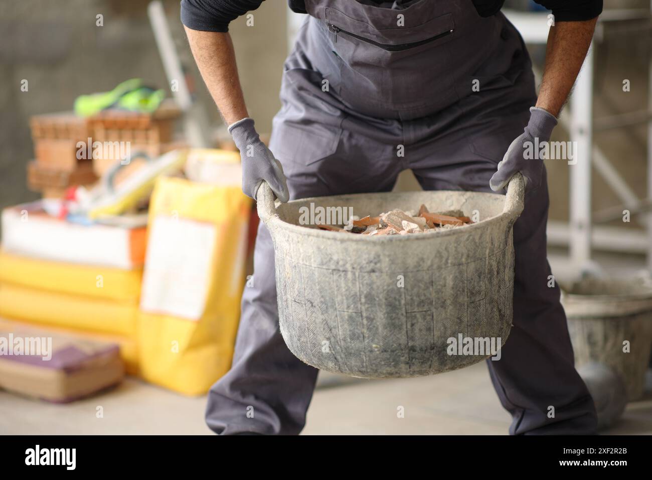 Detail of construction worker hands lifting carrycot in a house under ...
