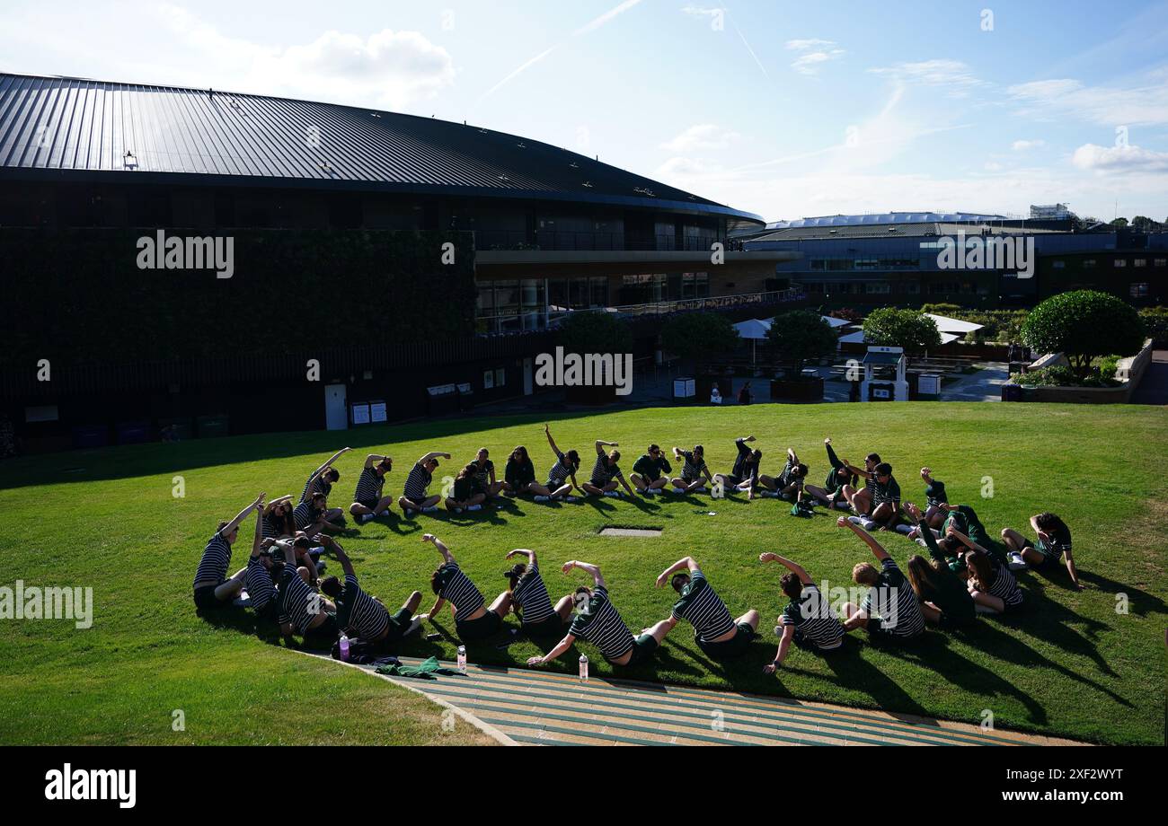 Ball kids exercise on day one of the 2024 Wimbledon Championships at ...