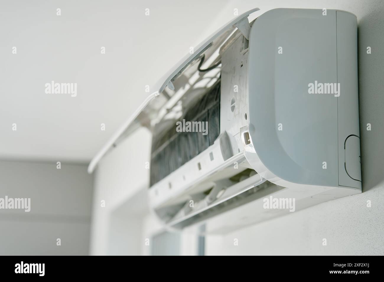 White air conditioner unit is mounted on wall, ready for maintenance ...