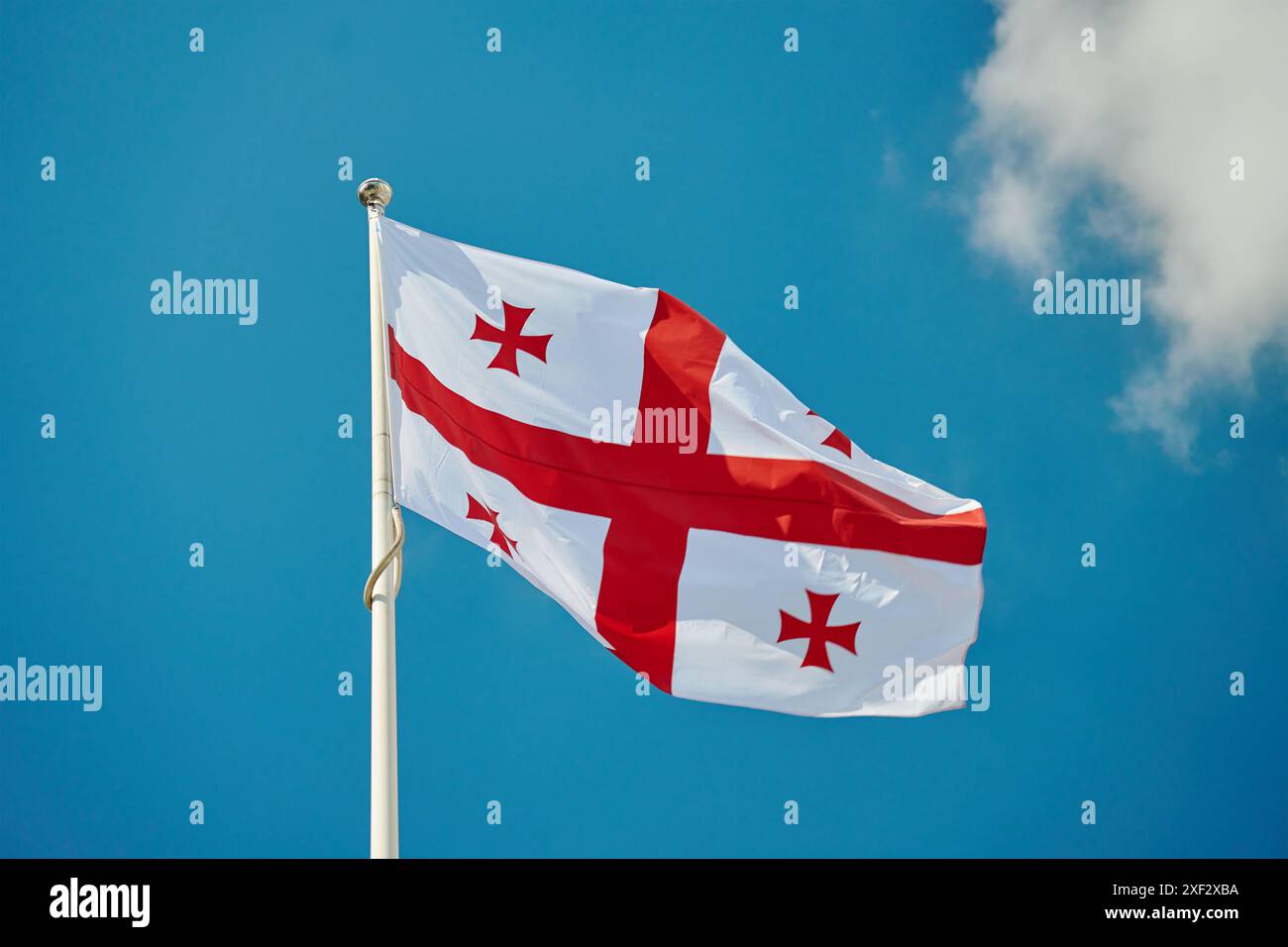 National flag of Georgia waves against bright blue sky Stock Photo - Alamy