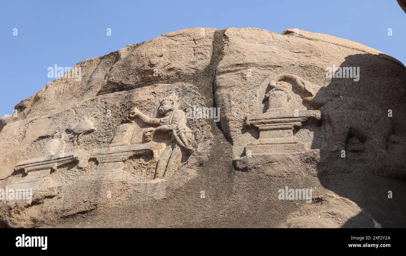 Carving of a king worshiping a Shivalinga on the rock surface of the ...