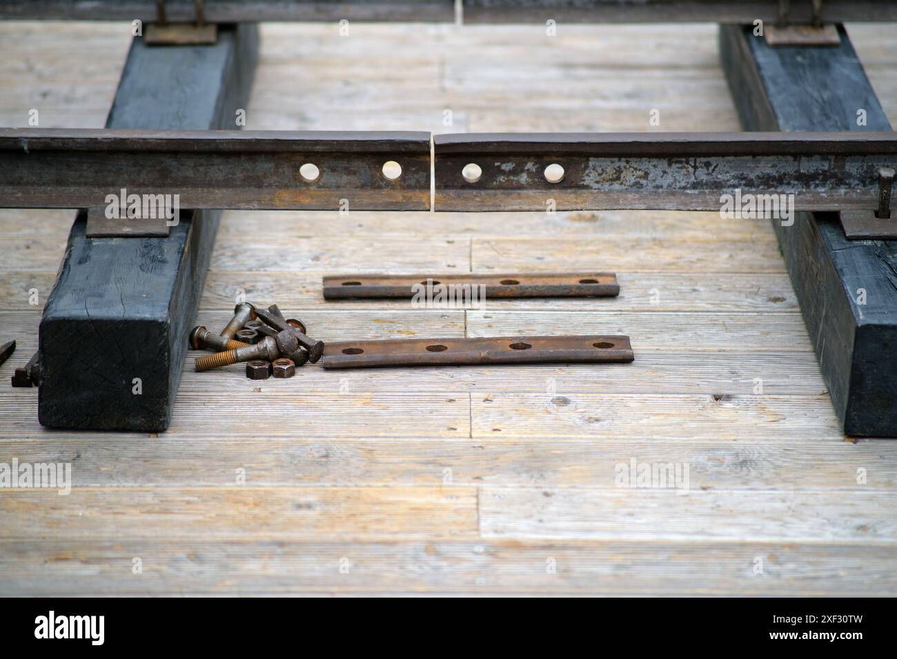 Assembling a railway track, aligning a metal rail with a fishplate ...