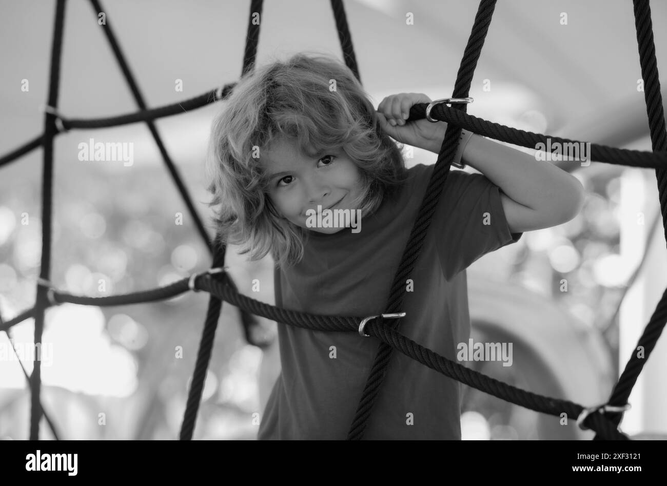 Cute kid having fun at playground. Happy kid having fun on playground ...