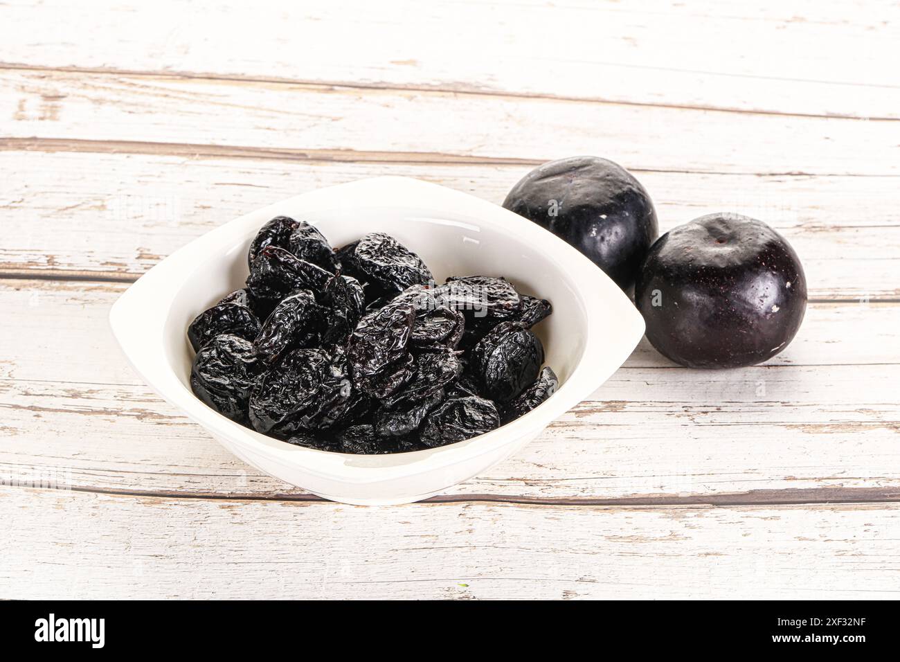 Dry sweet prunes in thw bowl Stock Photo - Alamy