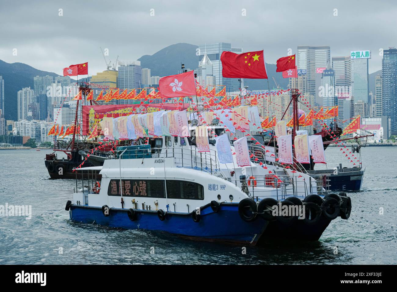 Hong Kong, China. 1st July, 2024. A vessel with flags of China and Hong ...
