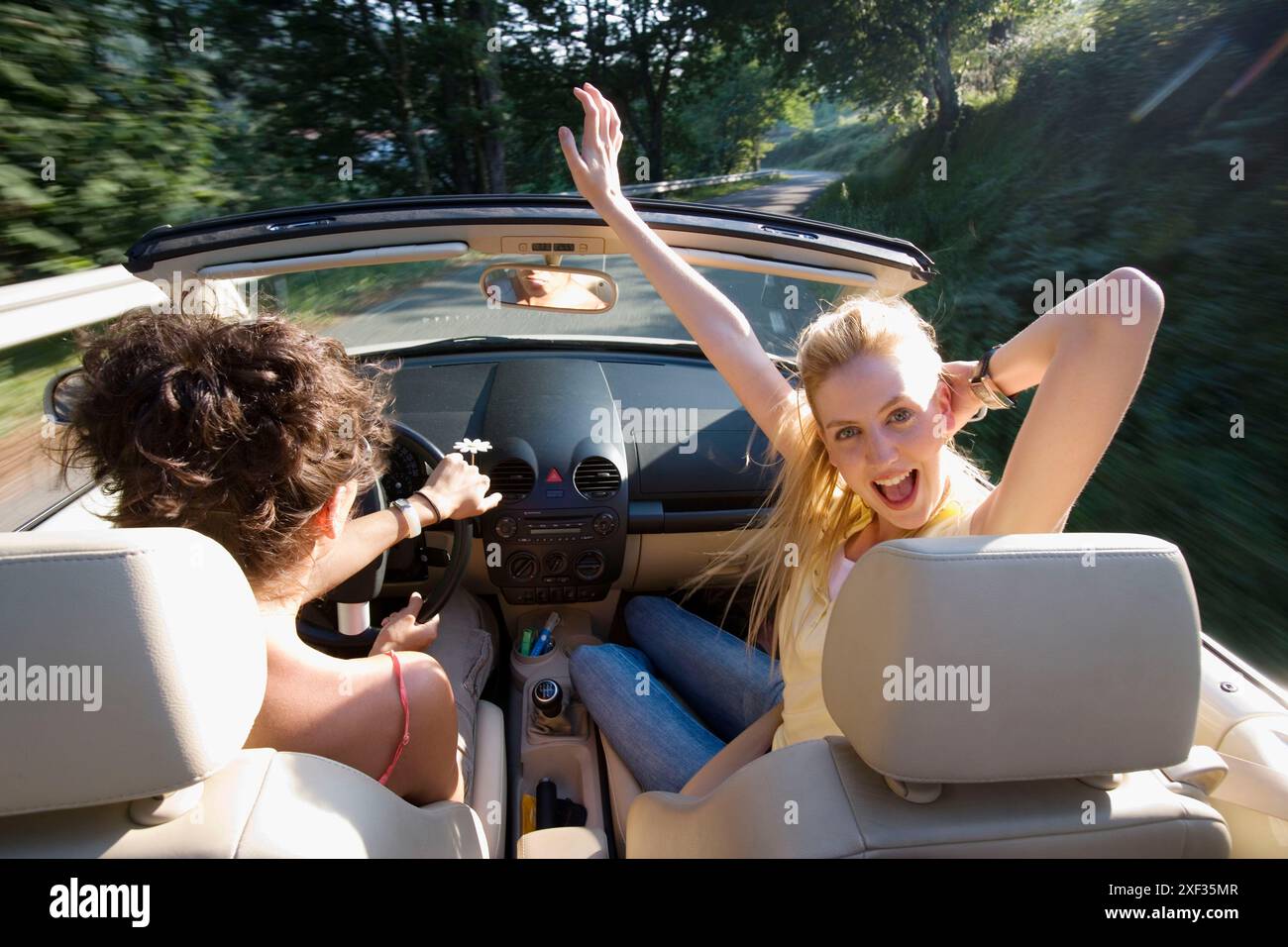 Two people car facing camera driving hi-res stock photography and ...