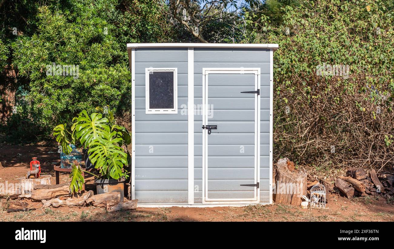 Outdoors small one room shed hut gray in color one door and window for ...