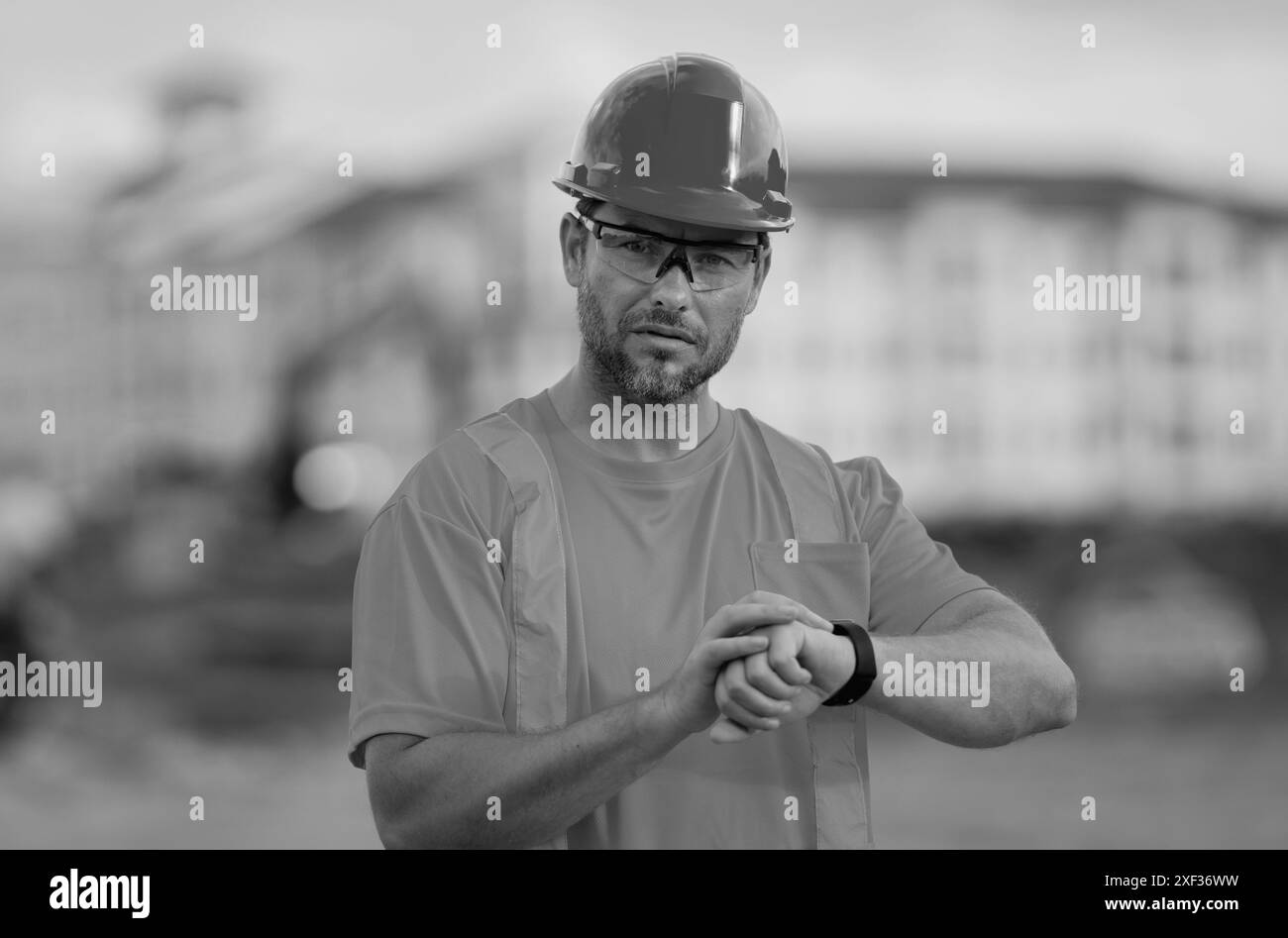 Construction site worker in helmet working outdoor. A builder in a ...