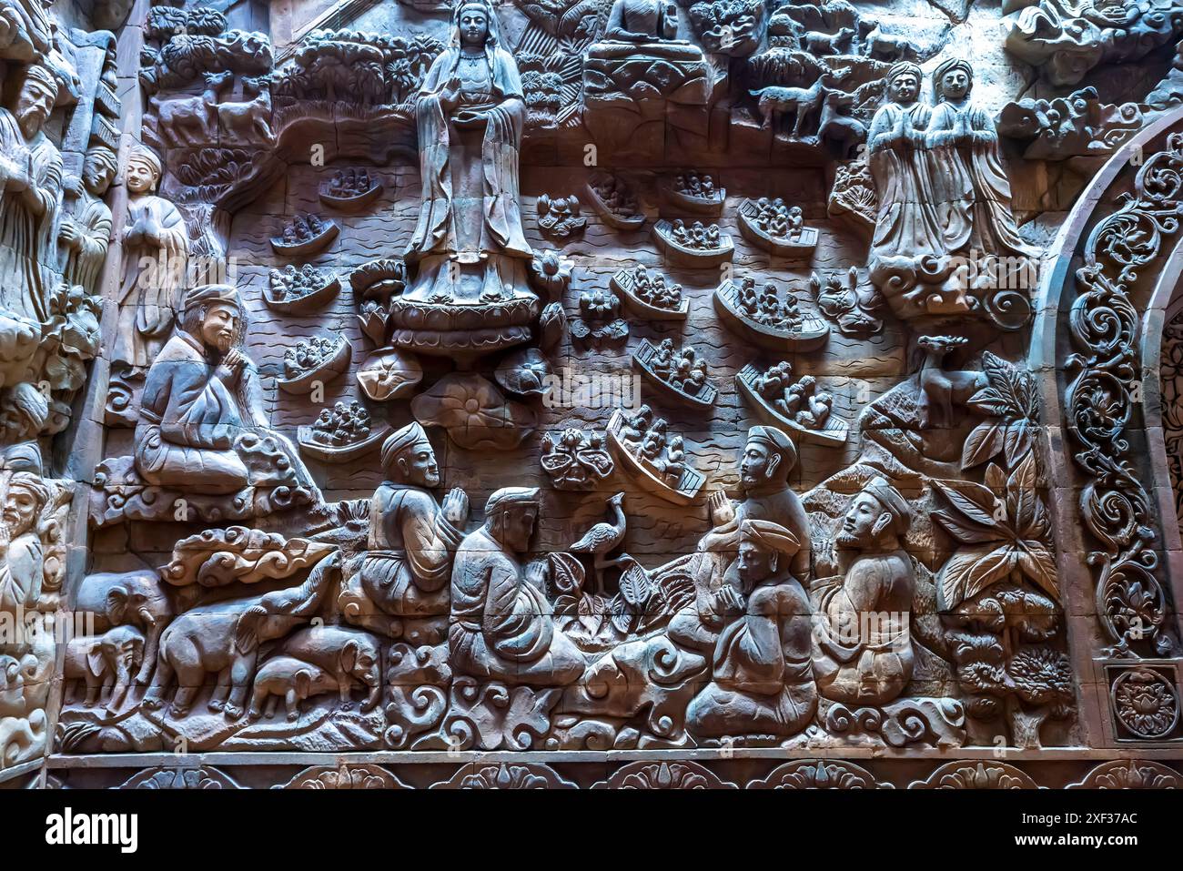 Stone carved base-relief of Ky Lan temple. Human figures and floral ...