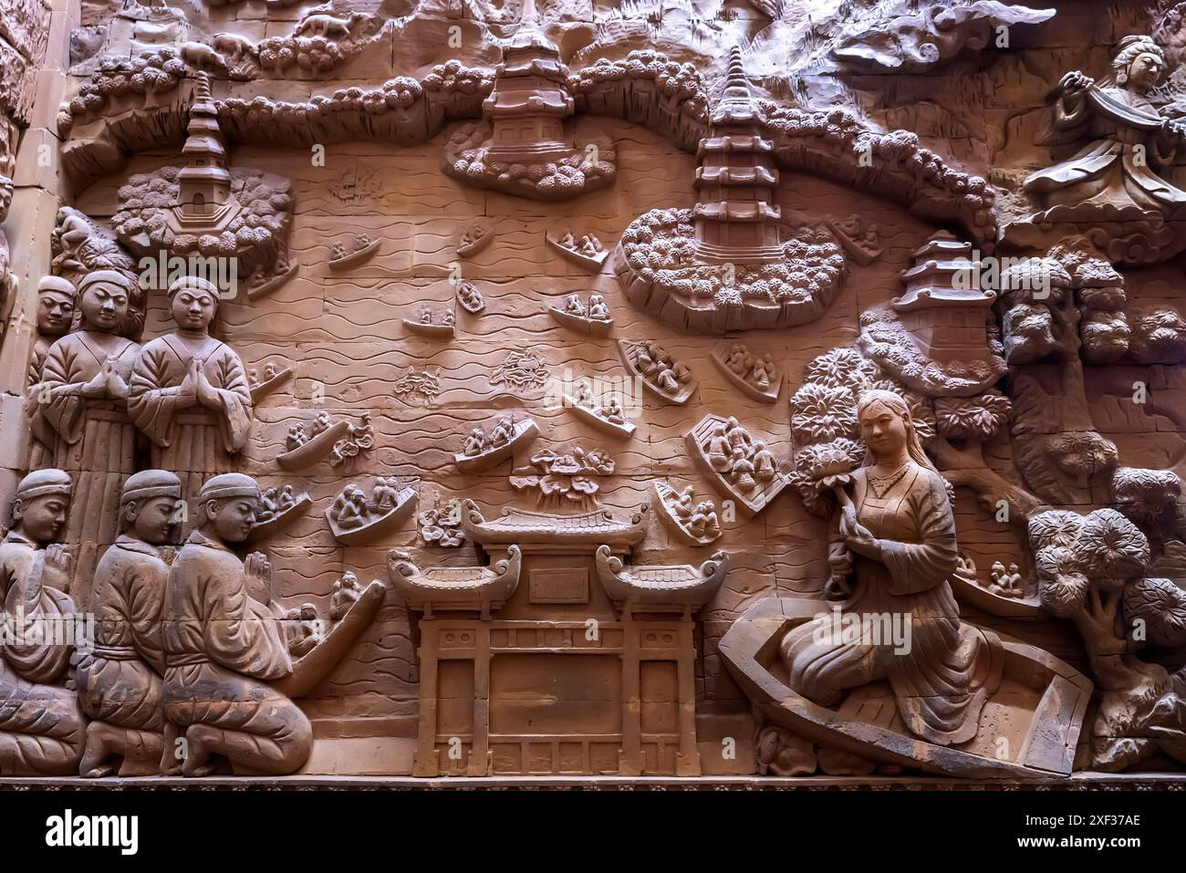 Stone carved base-relief of Ky Lan temple. Human figures and floral ...
