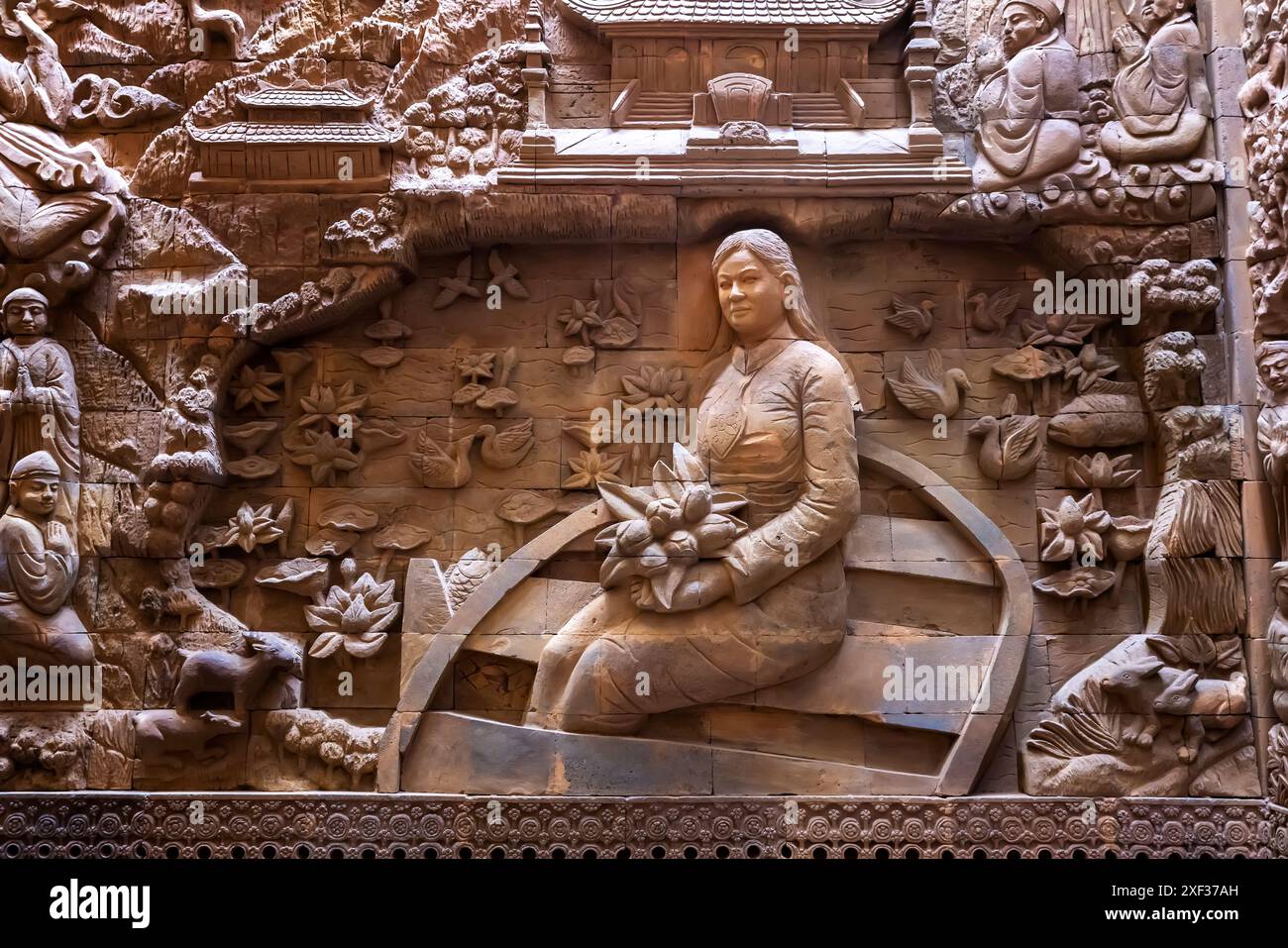 Stone carved base-relief of Ky Lan temple. Human figures and floral ...
