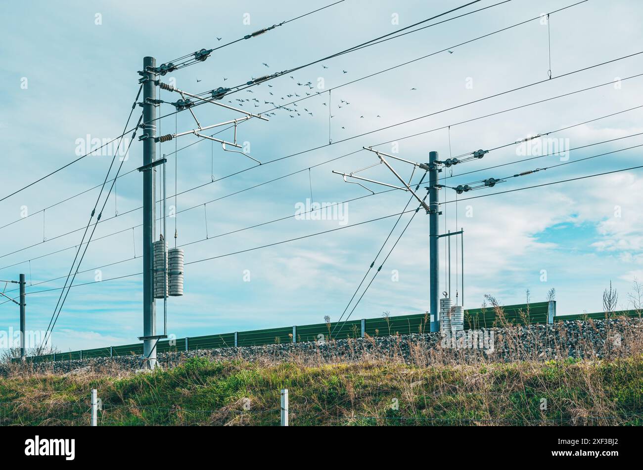 Electric train railway line tension pole with wires and concrete ...