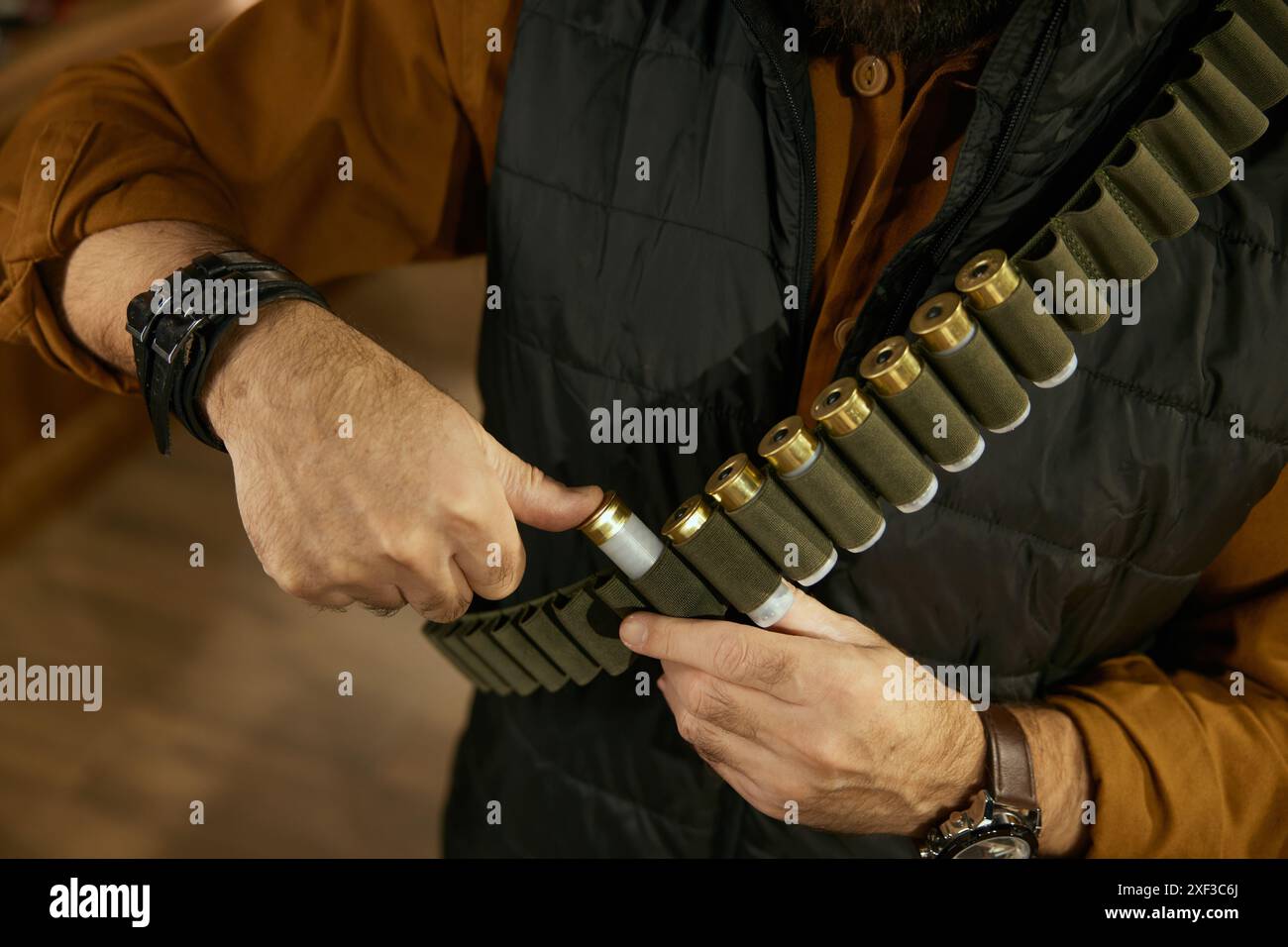Hunter hands placing bullets into the ammo belt closeup Stock Photo - Alamy