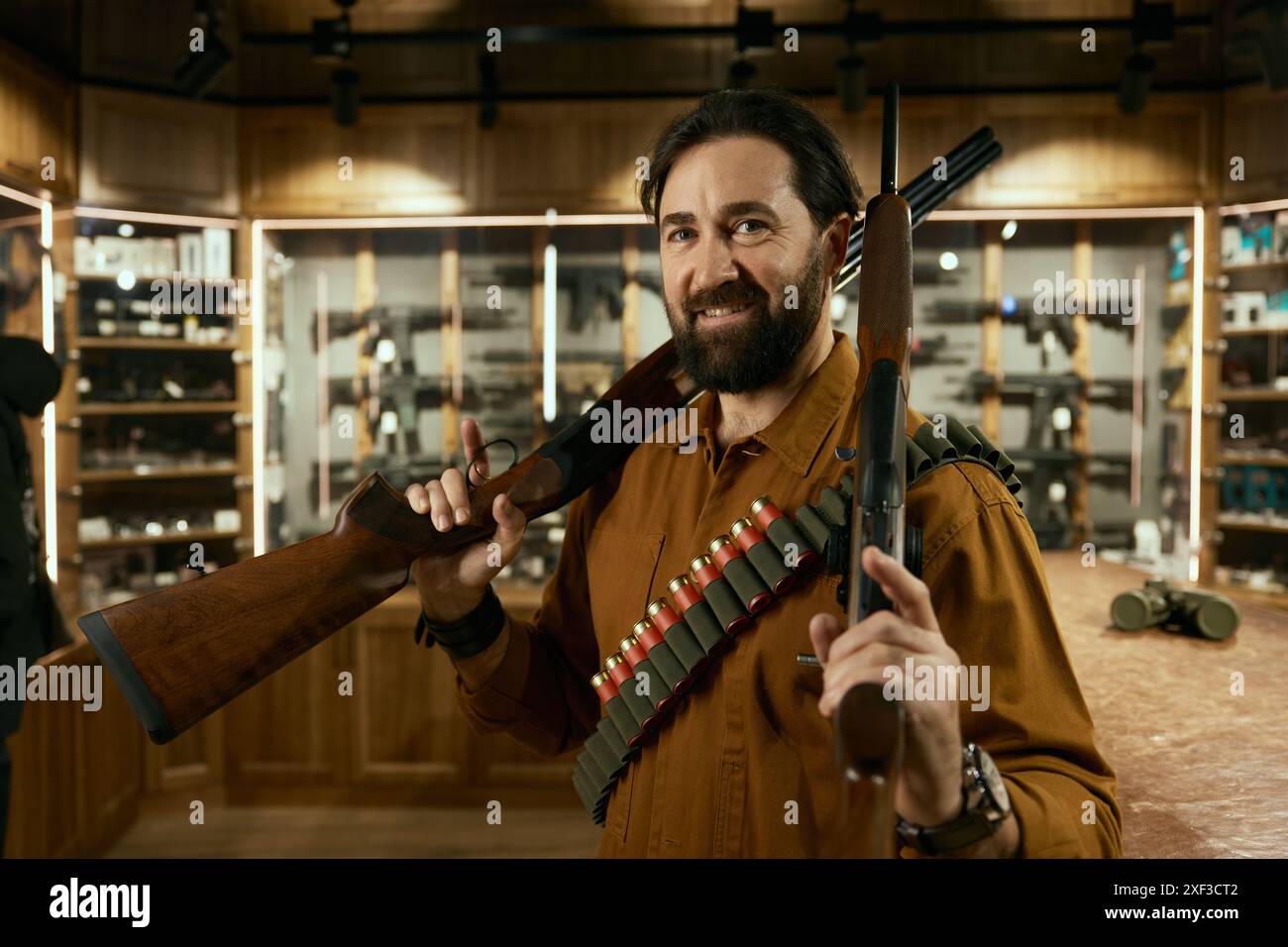 Portrait of hunter at weapon shop standing with rifles Stock Photo - Alamy