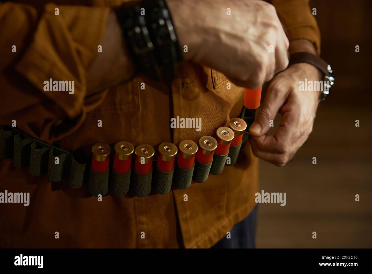 Closeup of hunter hands placing bullets into the ammo belt Stock Photo ...