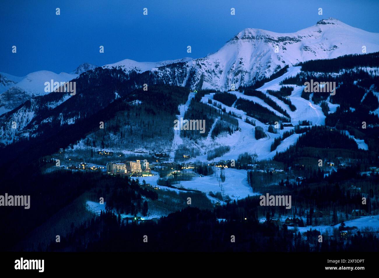 Mountain Village lit up at night in the winter and the slopes of the ...