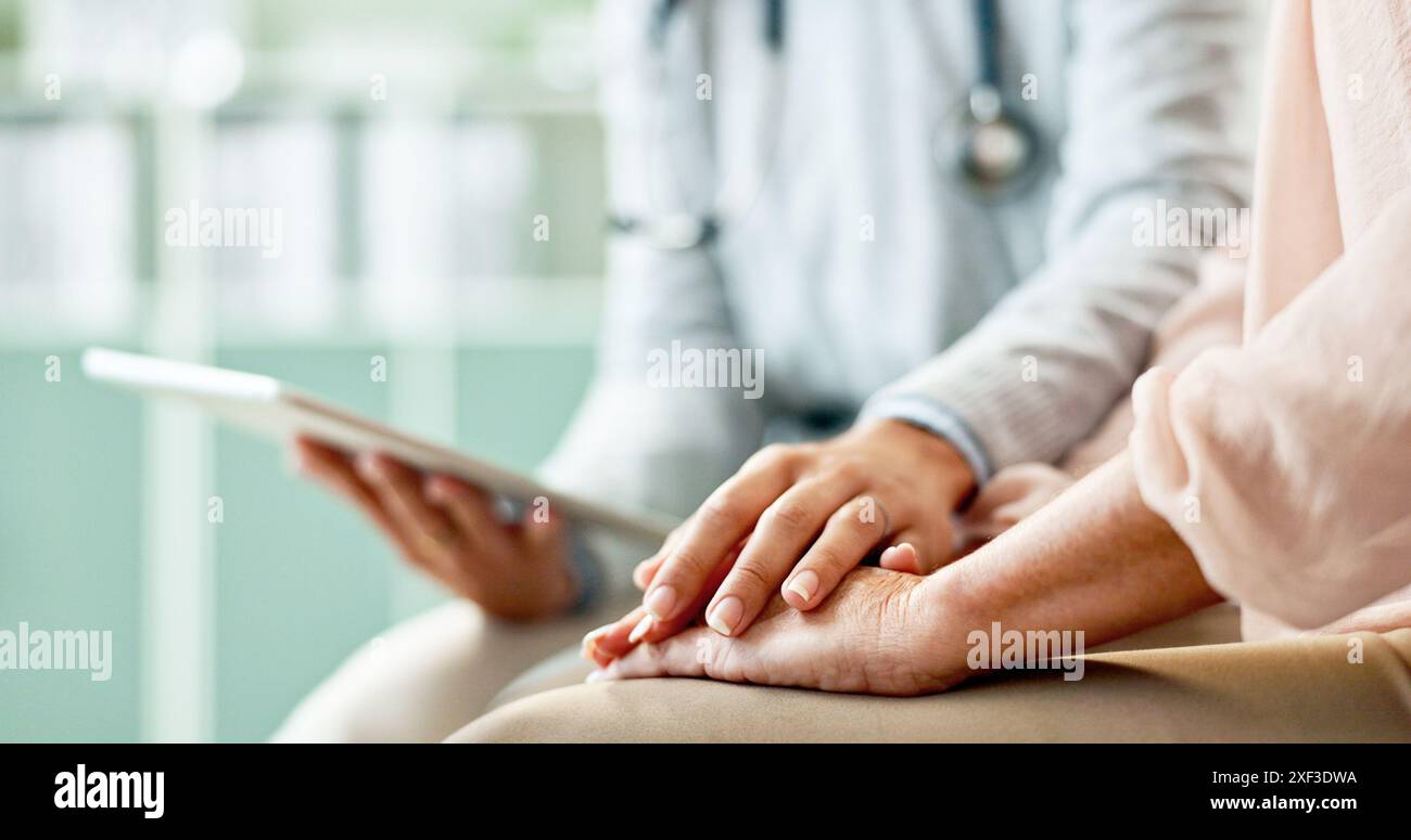 Doctor, patient and holding hands with tablet at hospital with support ...