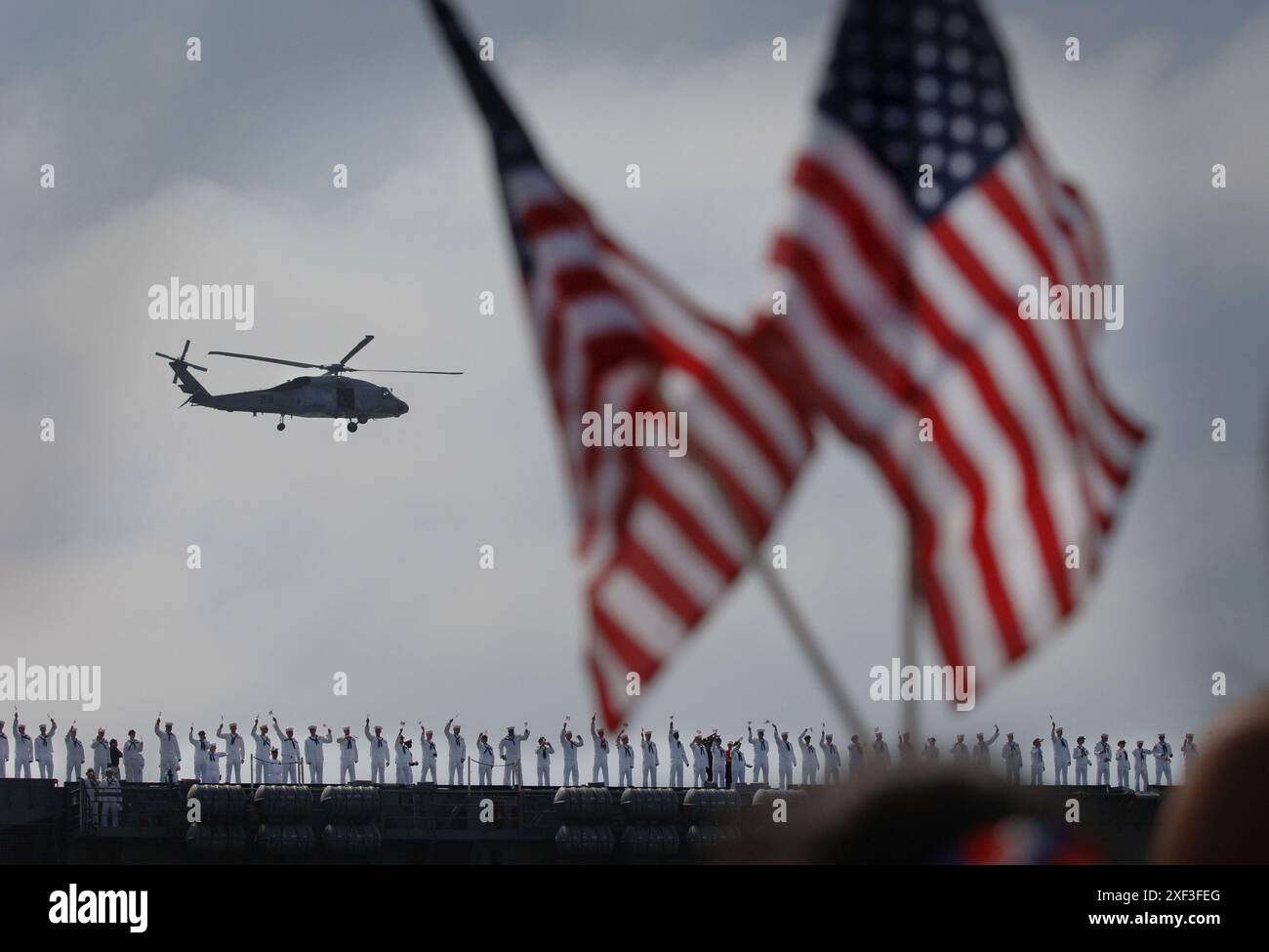 American flags in front of a Sailors on a Navy aircraft carrier Stock ...