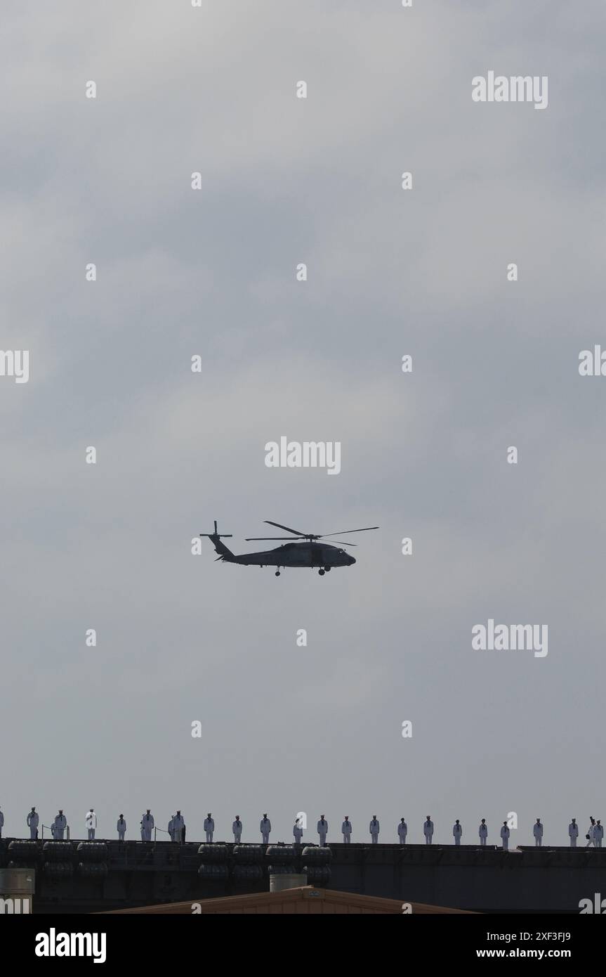 Helicopter flies over aircraft carrier Stock Photo - Alamy