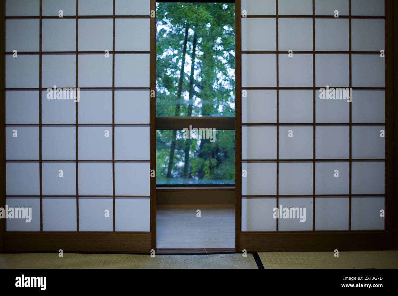 A traditional Japanese room with sliding paper doors and tatami mat ...