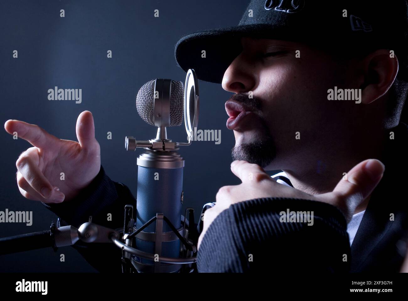 A rapper sings into a microphone in Chula Vista, California Stock Photo ...