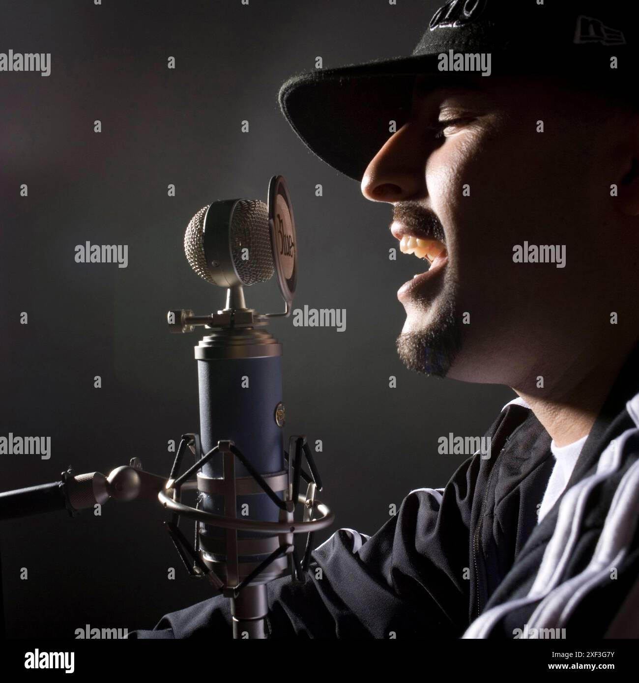 A rapper sings into a microphone in Chula Vista, California Stock Photo ...