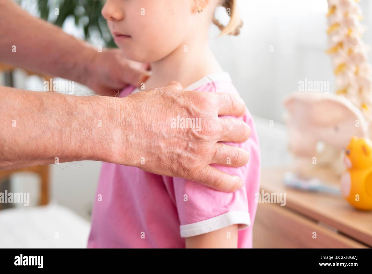 male Orthopedist doctor examining child's back in clinic, physician ...