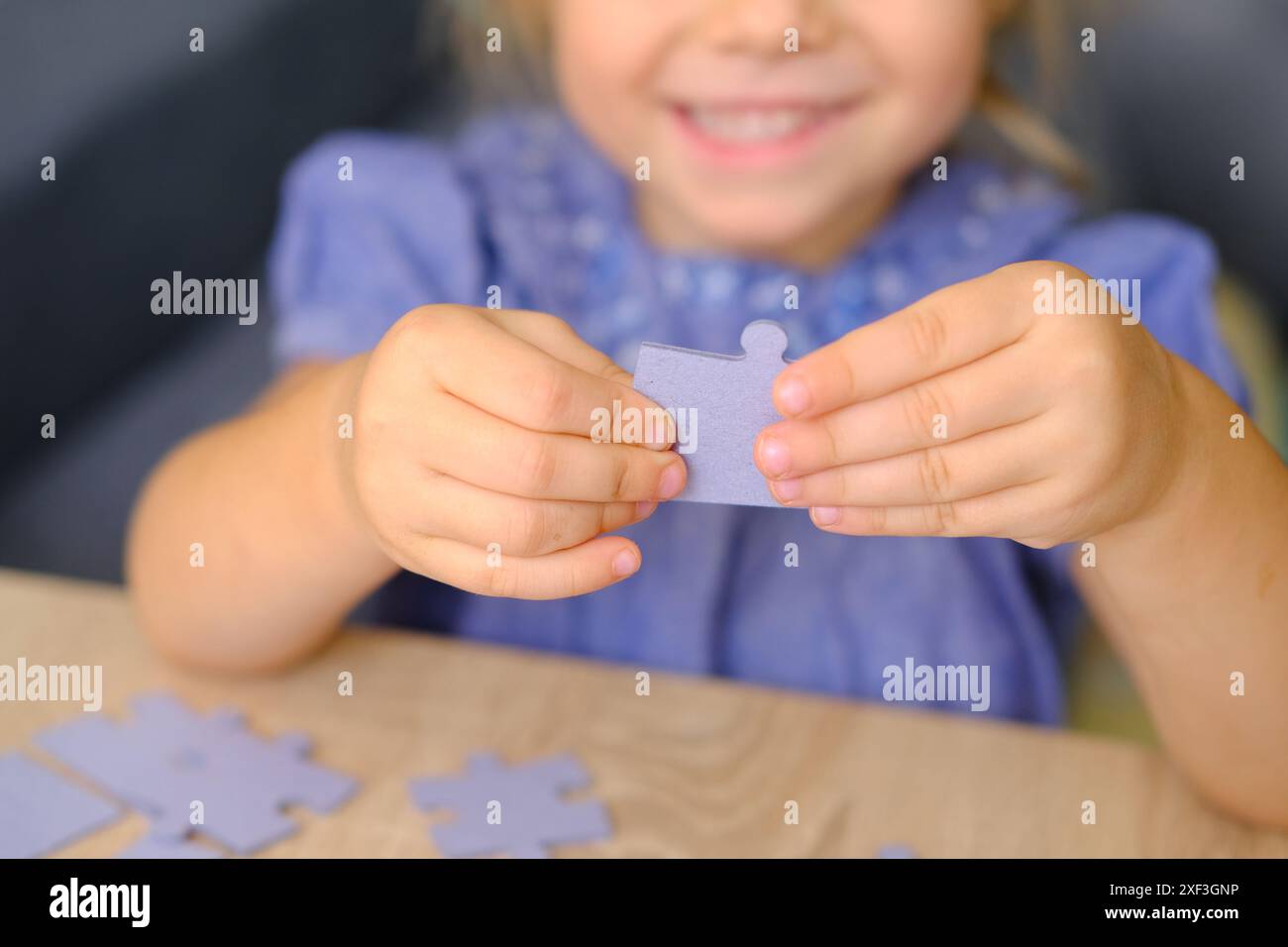 happy funky girl 3 years old assembling puzzles, sorting cardboard ...