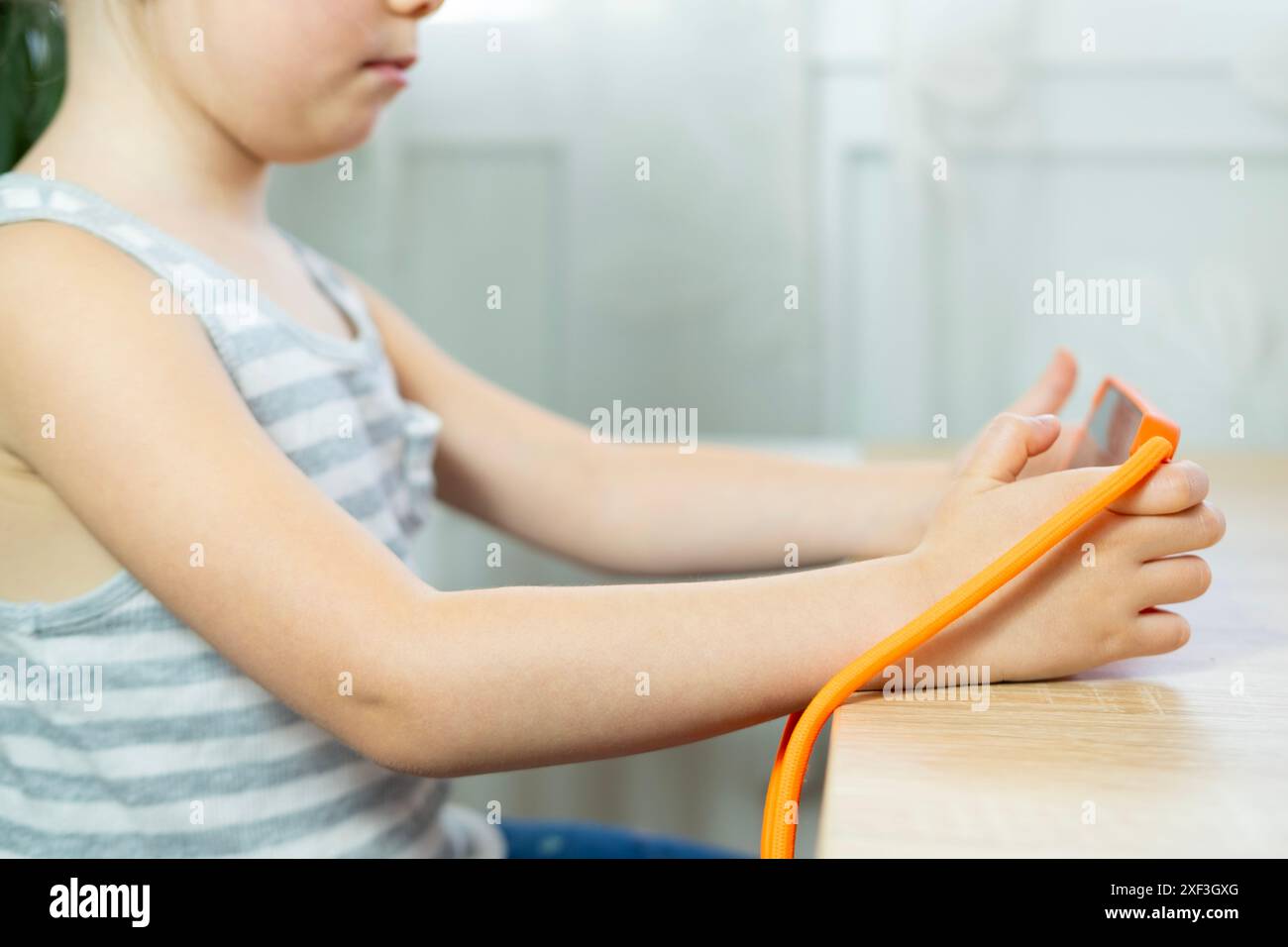 young girl maintains good posture while using phone, sitting with ...