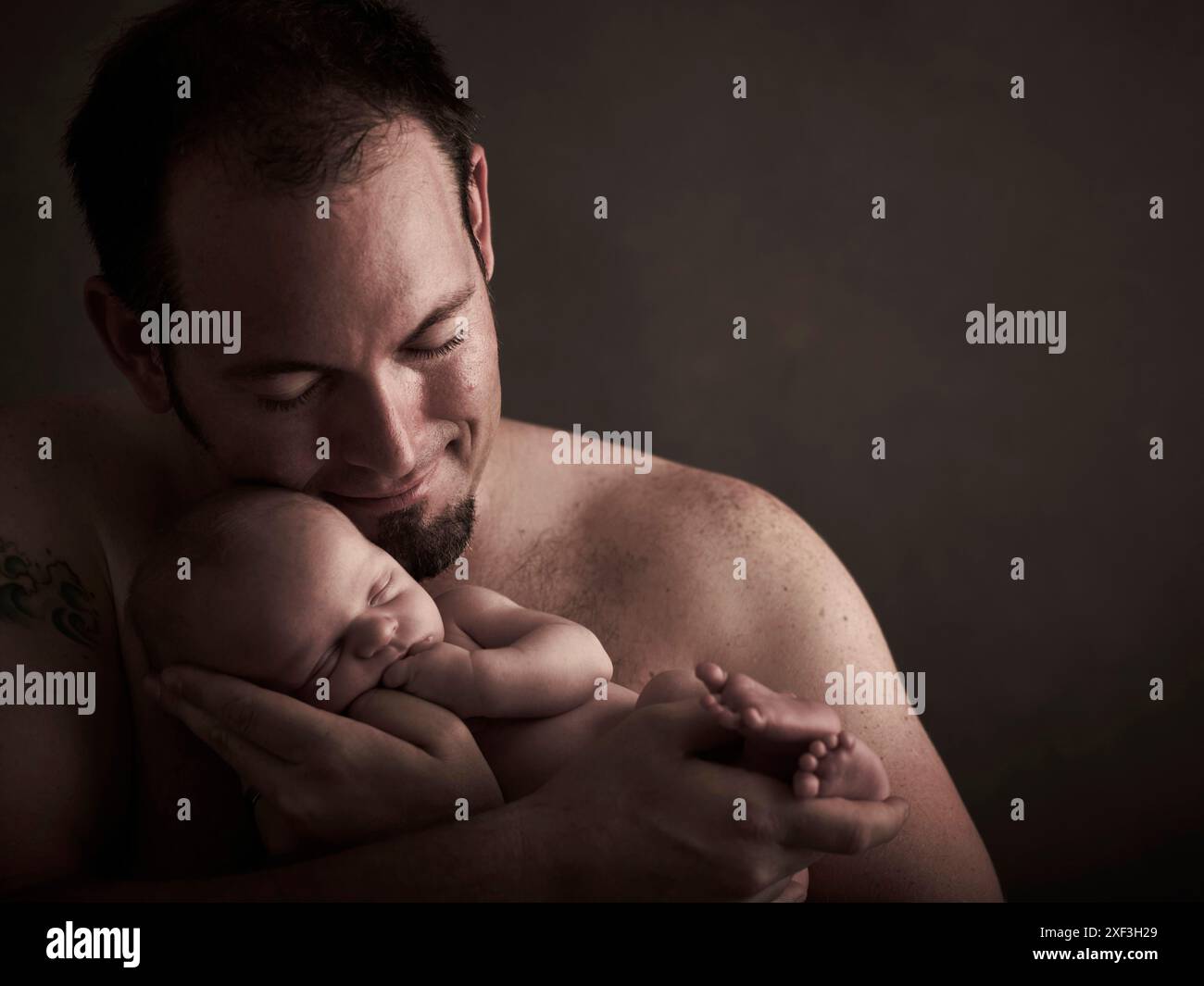 Male parent holding his baby child close to his face Stock Photo - Alamy