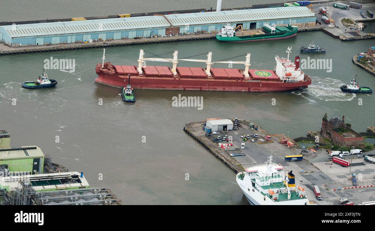 Ship being manouvered by tug boats at Seaforth Docks, Liverpool ...
