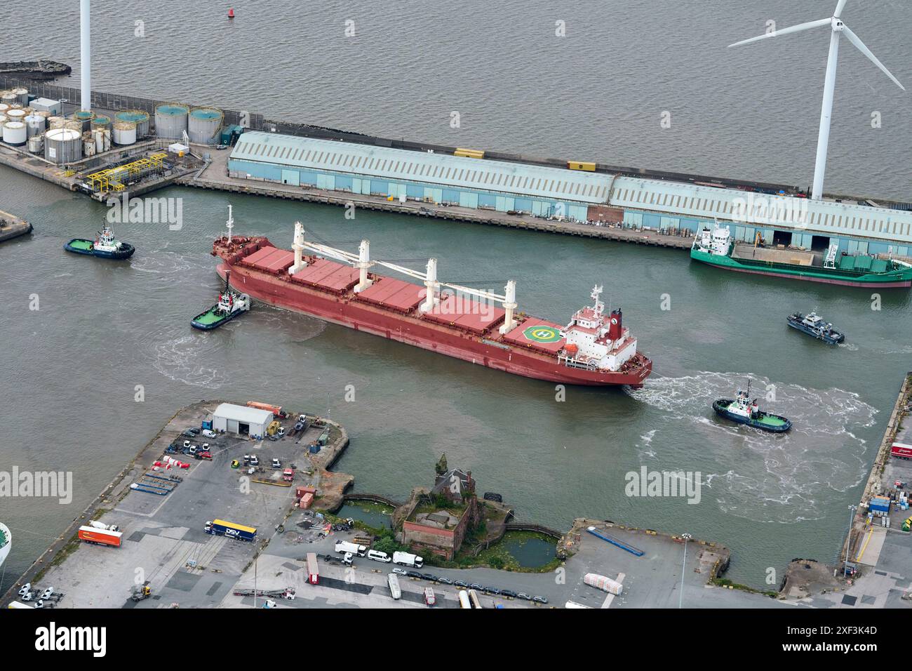 Ship being manouvered by tug boats at Seaforth Docks, Liverpool ...
