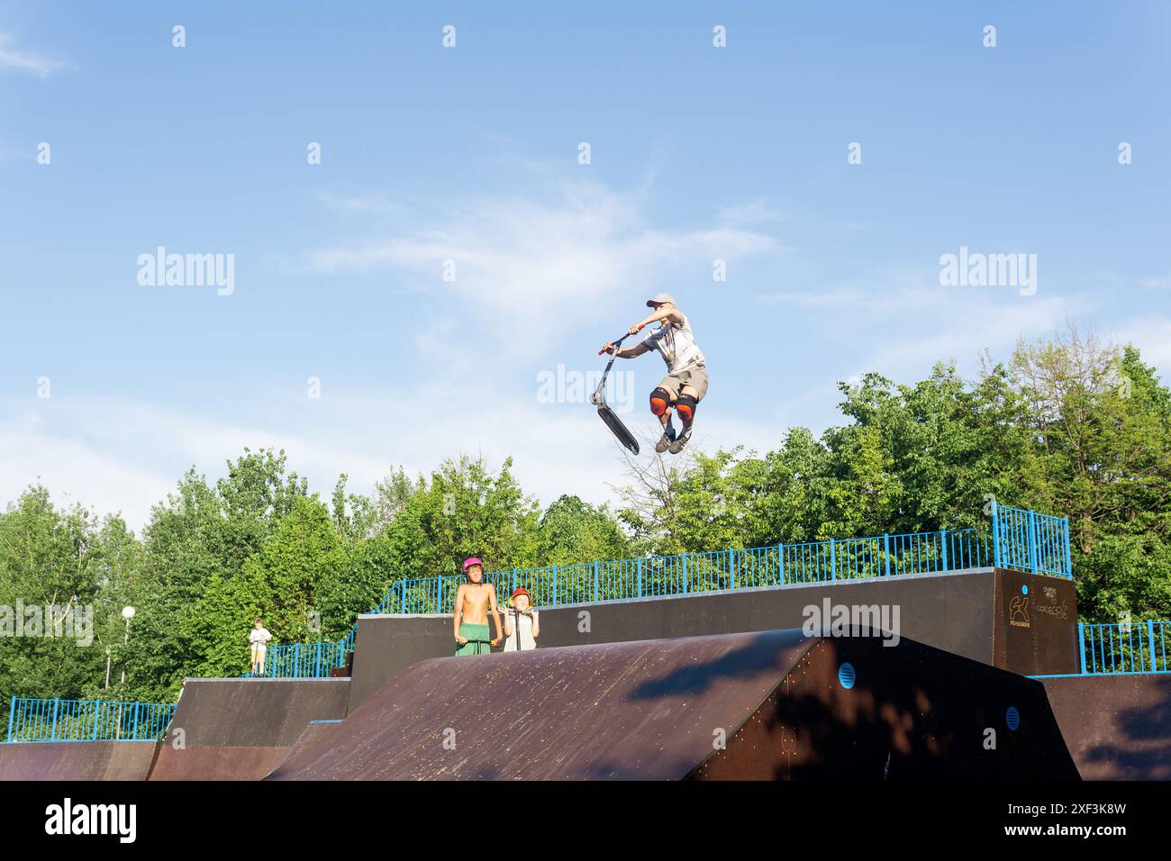 Saint Petersburg, Russia - June 05, 2024: teenagers ride and jump on ...