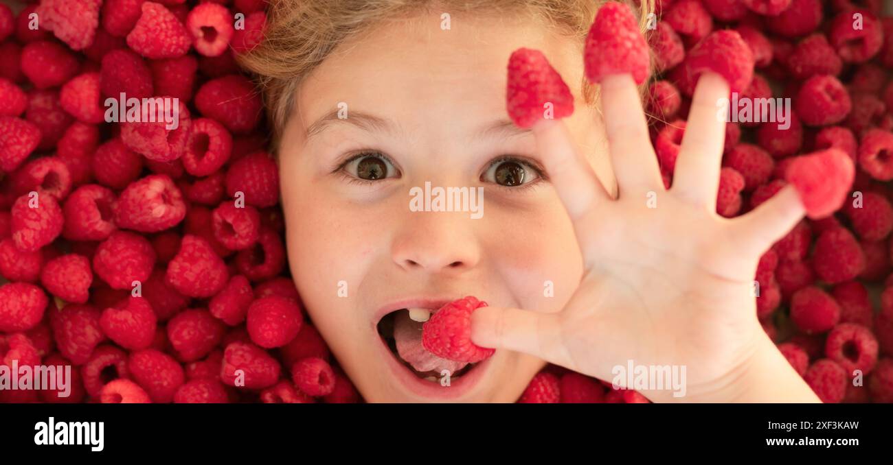 Funny excited kids face near raspberry background, close up studio ...