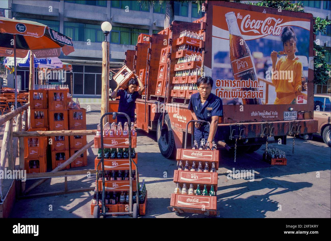 Thailand - Coca Cola workers are offloading bottles from a Coca Cola ...