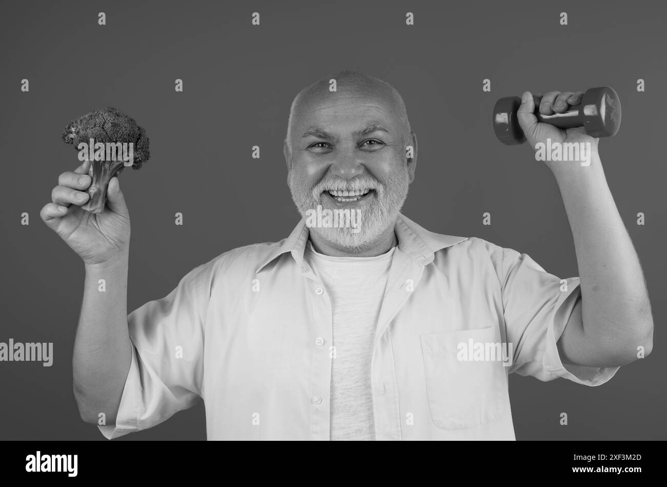Healthy Senior. Healthy food. Power old mature man hold dumbbell and ...