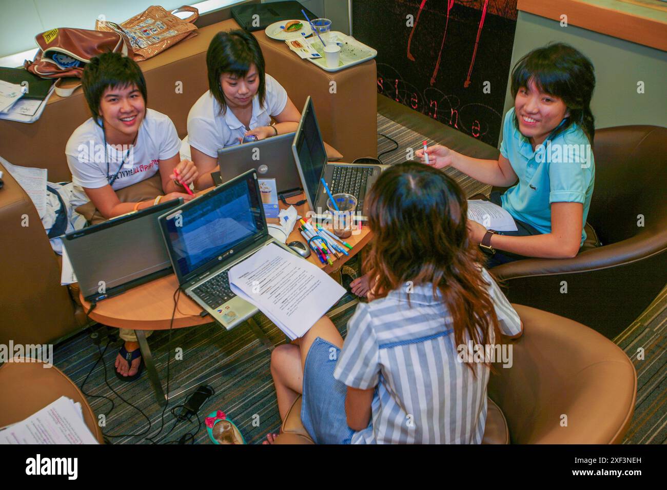Thailand, Bangkok. Students work on their laptops in a bar Stock Photo ...