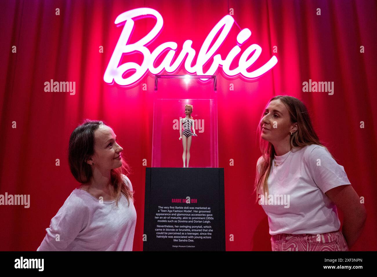 London, UK. 1 July 2024. Staff members with 'Number 1 Barbie', 1959 ...