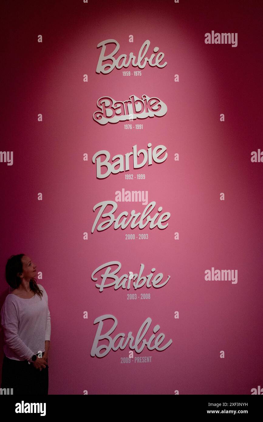 London, UK. 1 July 2024. A staff member with 'The Barbie Logo', 1959 ...