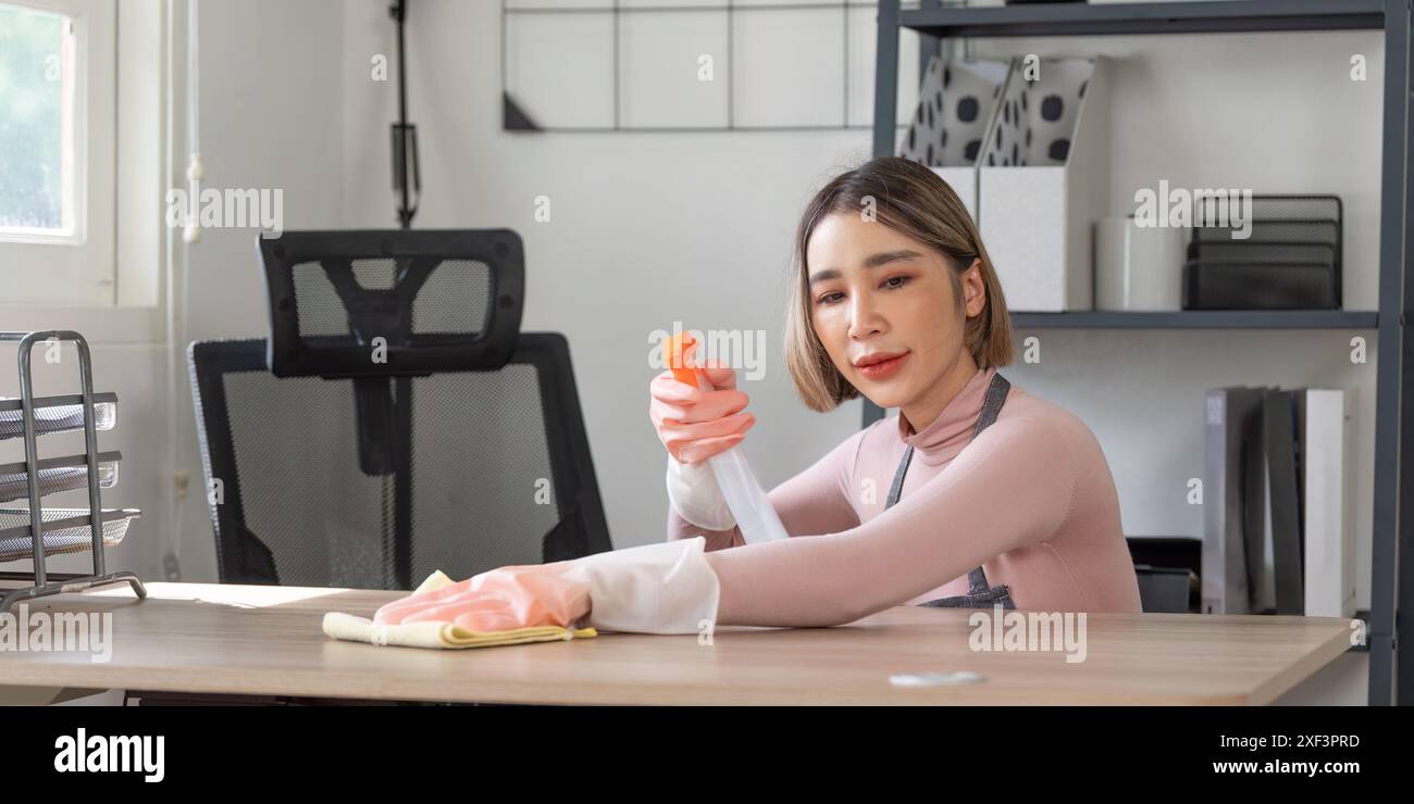 Professional Housekeeper Cleaning Office Desk with Spray Bottle and ...