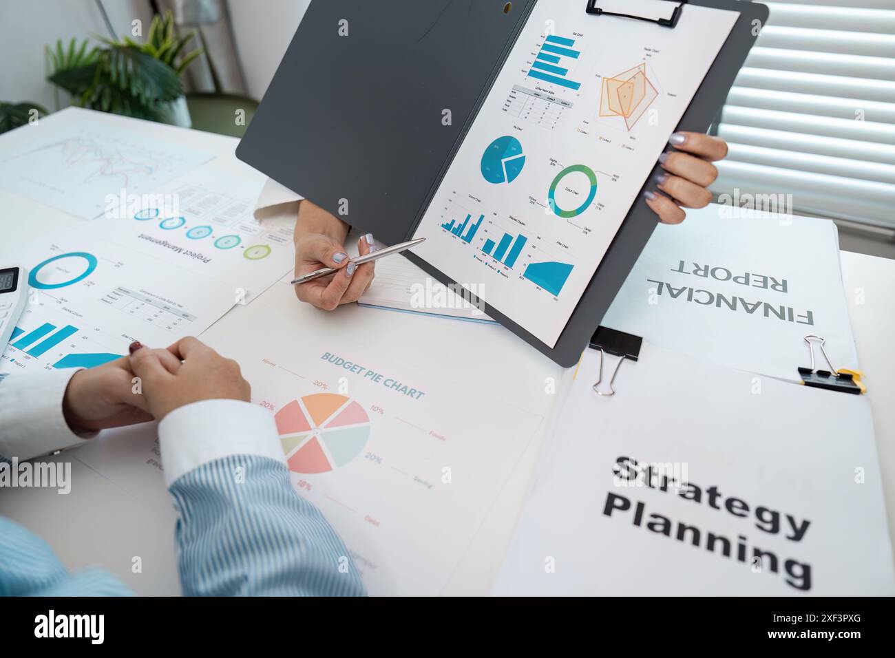Business Strategy Planning Meeting with Financial Reports and Data ...
