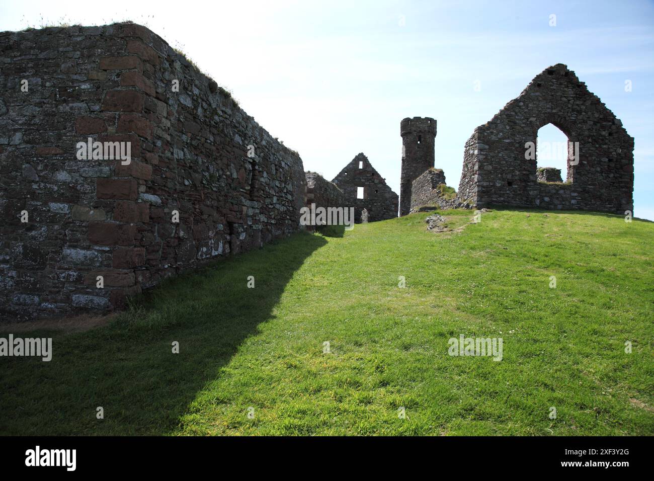 The 11th.Century Round tower and ruins of St.Patrick's Church in Peel Castle at Peel in the Isle ...