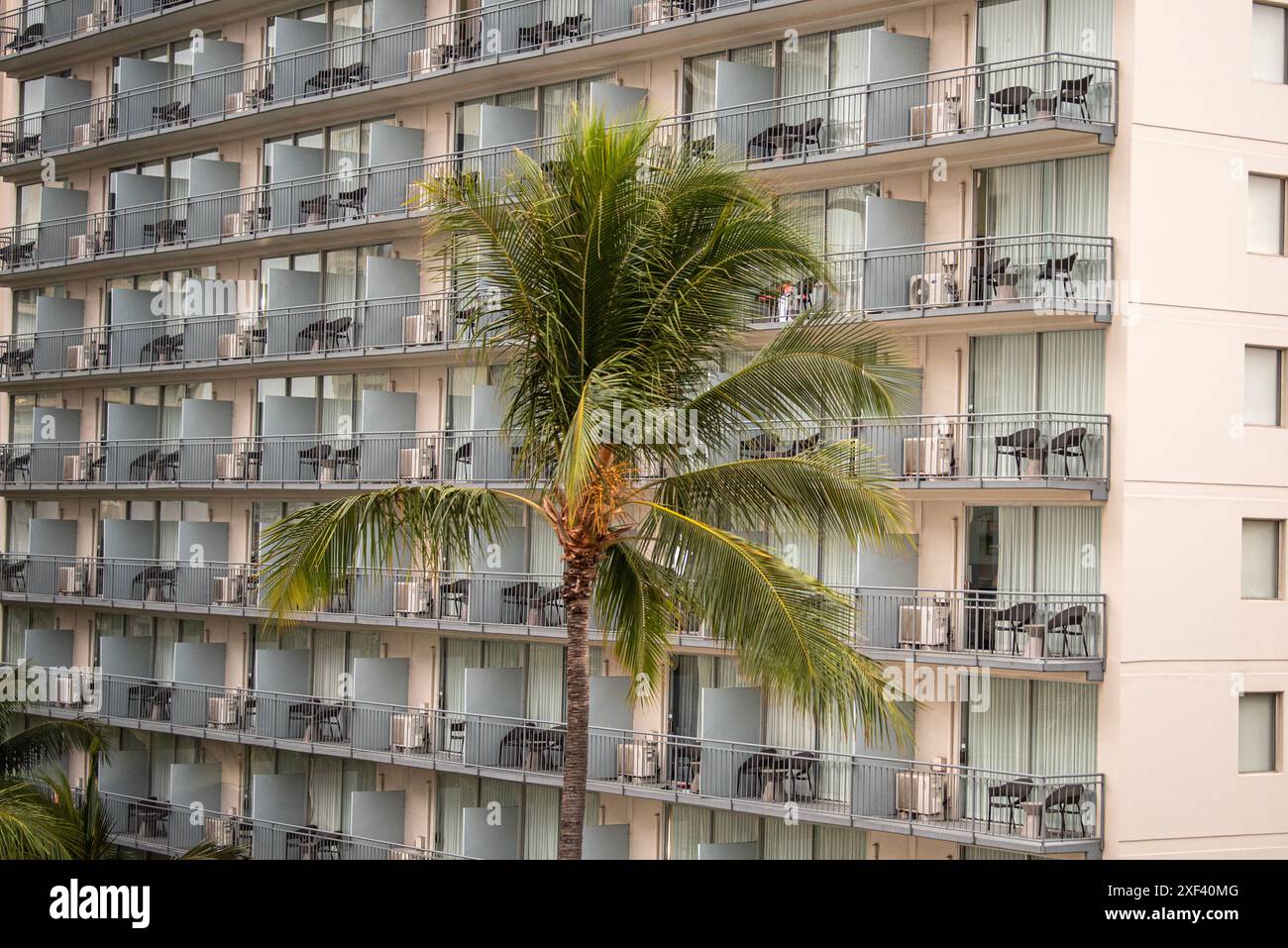 A towering apartment building in Honolulu stands tall against the sky ...