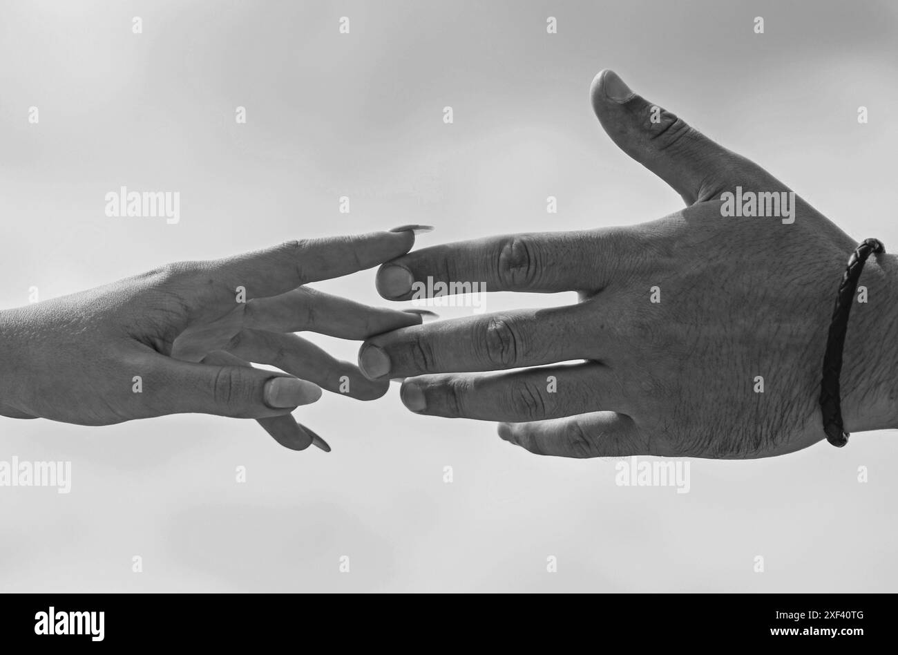 Hands reaching for each other Black and White Stock Photos & Images - Alamy