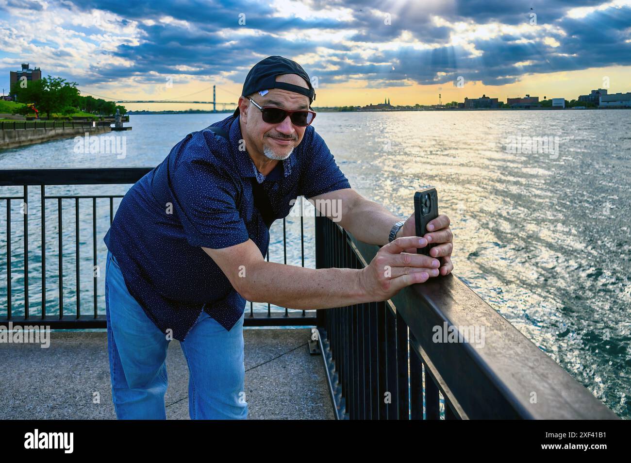 Tourist man taking pictures in the riverfront district, Windsor, Canada ...