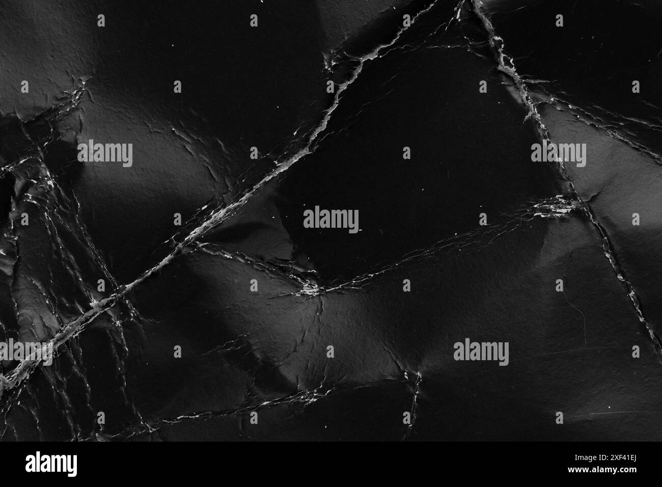 Crumpled black paper cracked textured background with rough torn ...